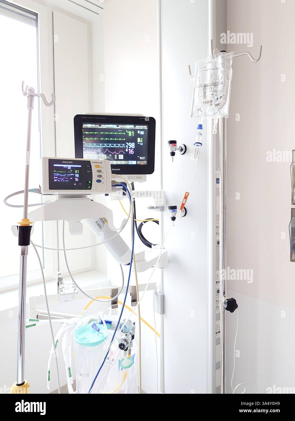 ECG or EKG or electrocardiogram monitor and IV drip stand next to ...