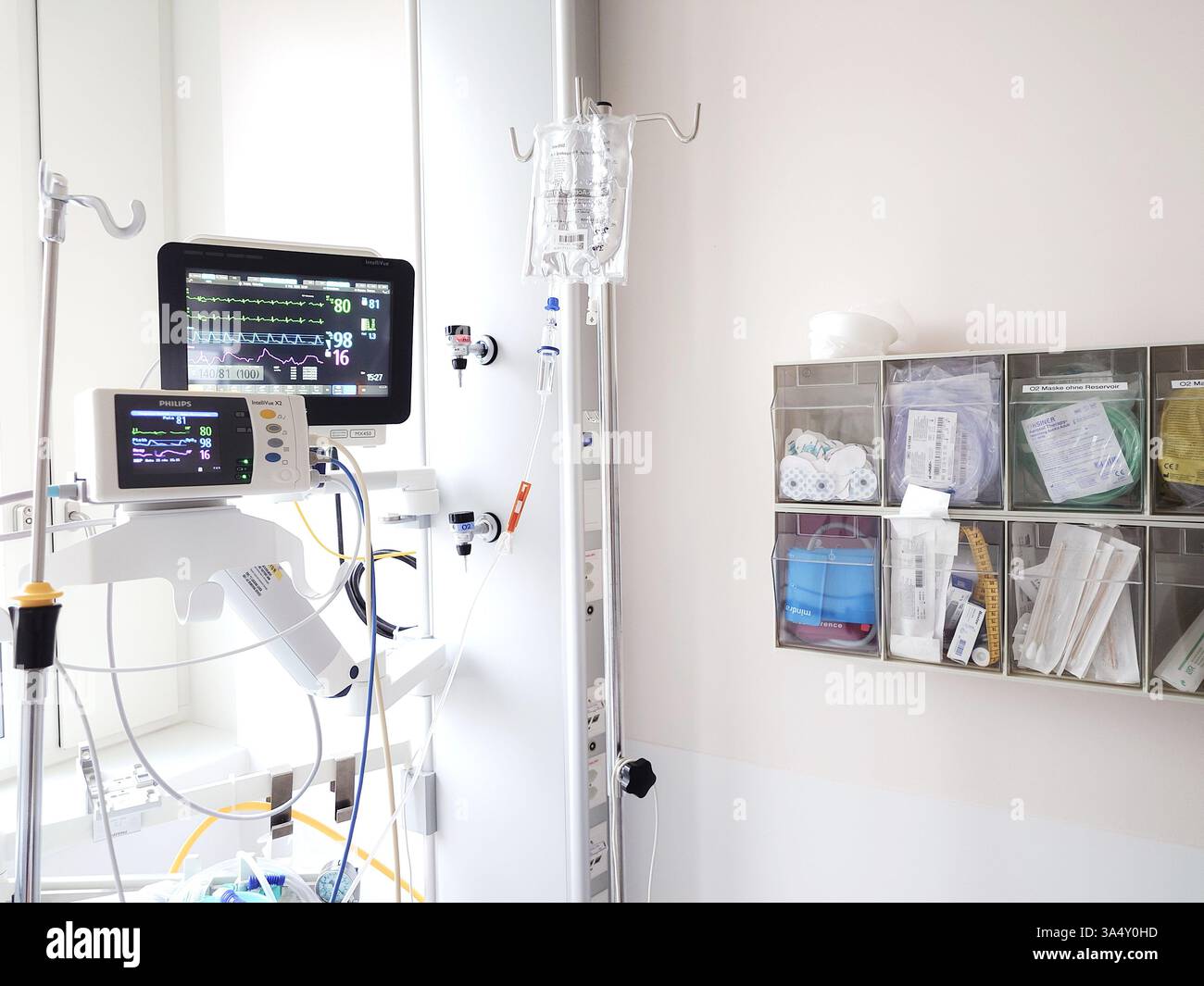 ECG or EKG or electrocardiogram monitor and IV drip stand next to ...