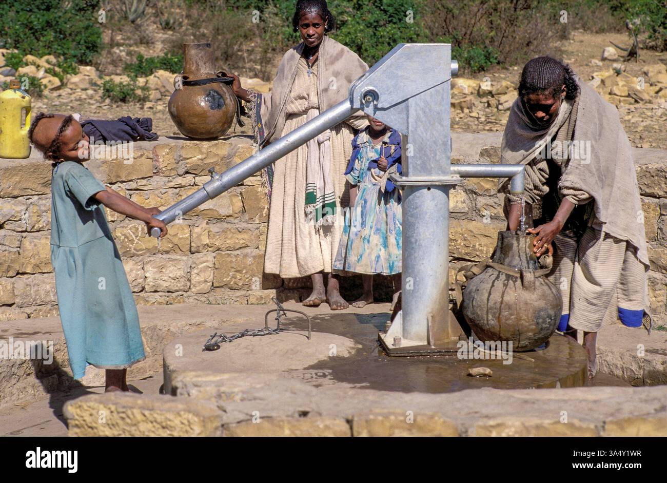 Ethiopia, Tigray; Women and girls tapping water at a waterpump ...