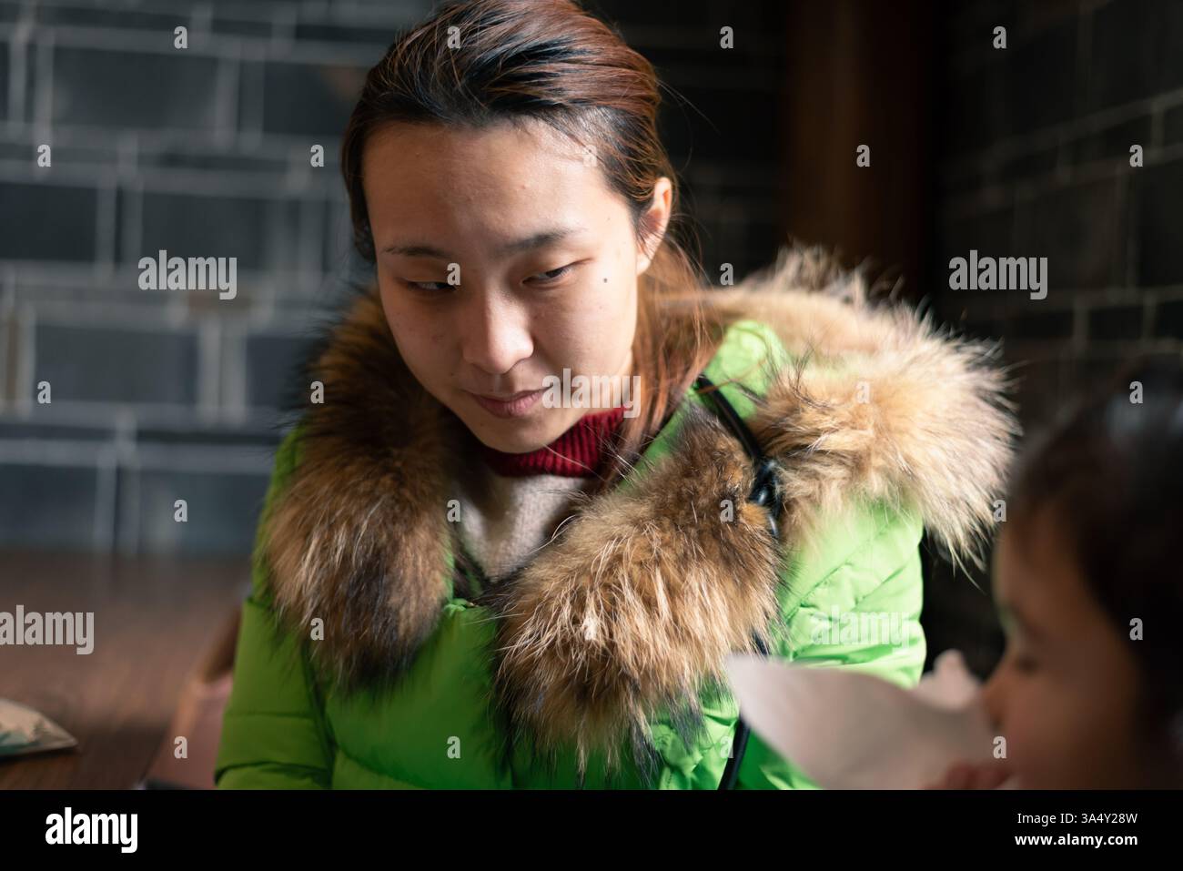 Beautiful Chinese woman splitting some food with her multiracial ...