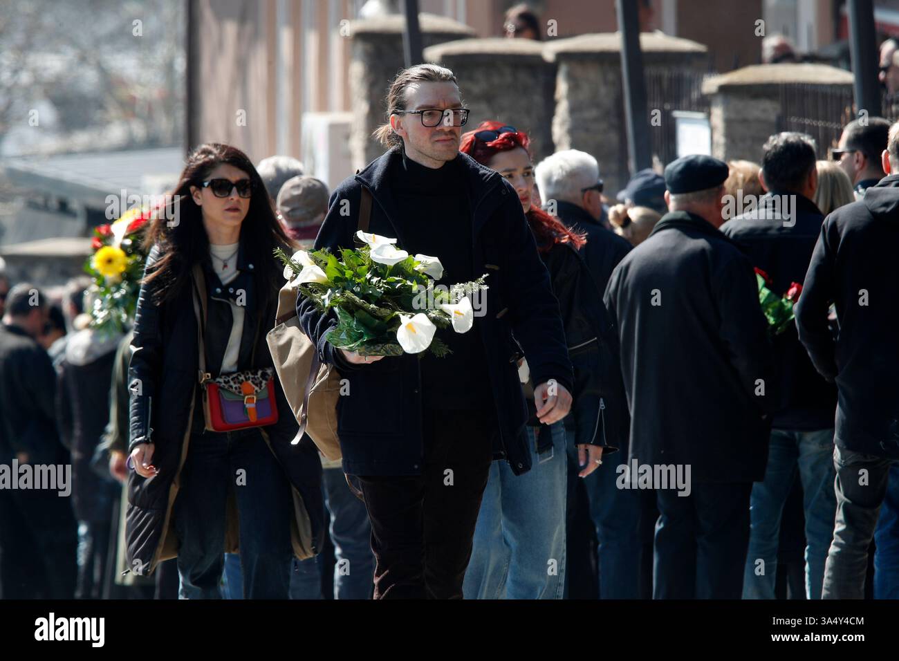 People carrying flowers arrive for the funeral of Andrej Gjorgieski ...