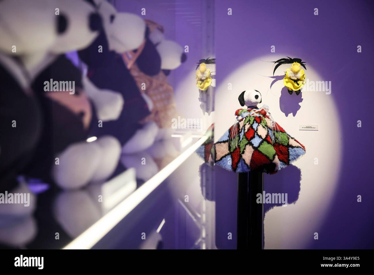 Figurines representing Snoopy wear creations as part of Peanuts' 75th ...