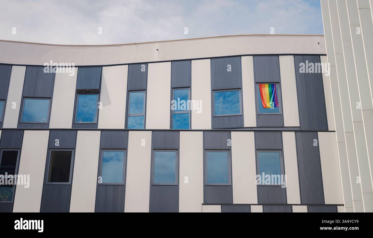 Facade of modern building with sleek design, displaying LGBTQ pride ...