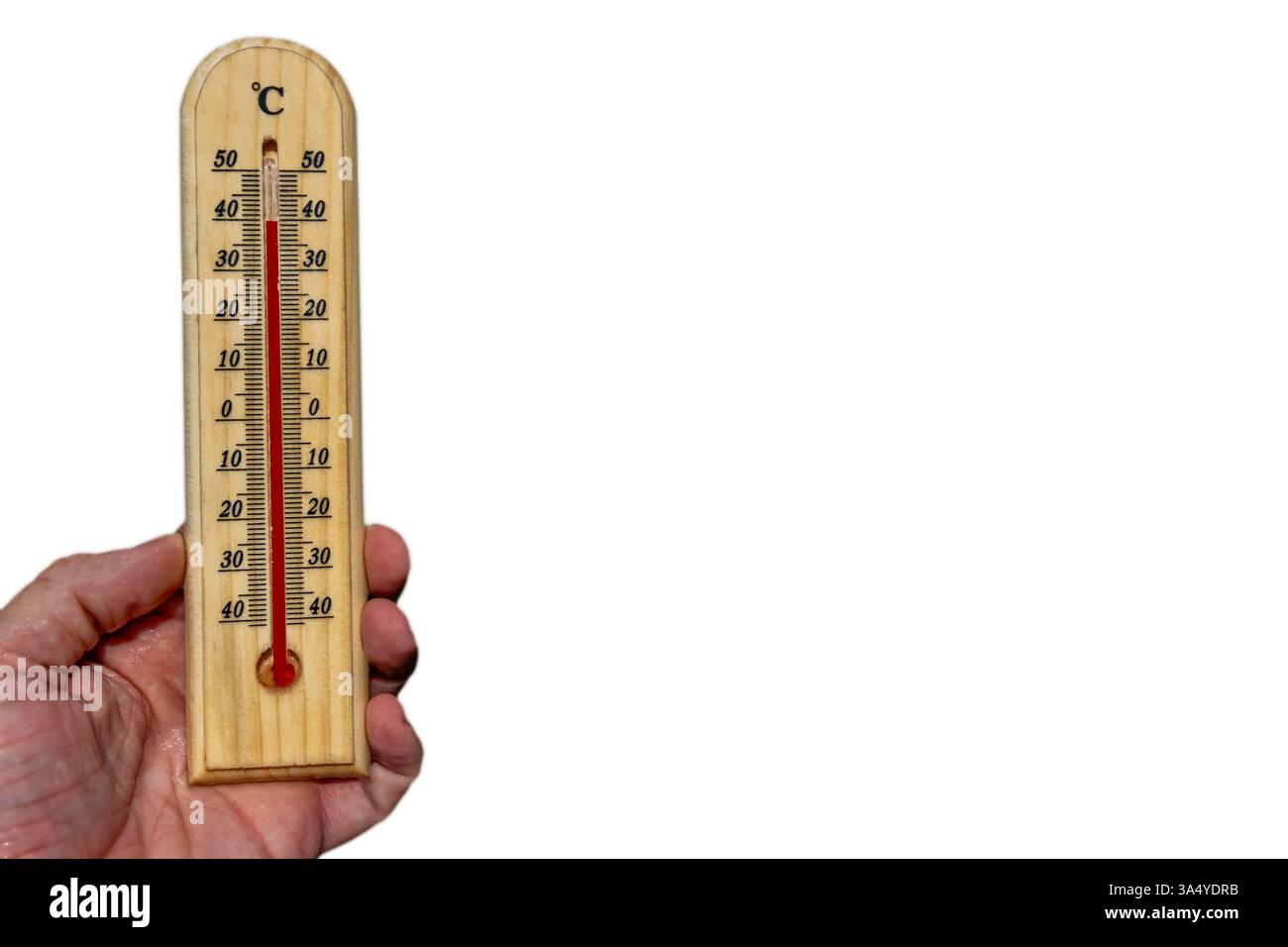 Wooden thermometer indicating high temperature, held in hand, measuring ...