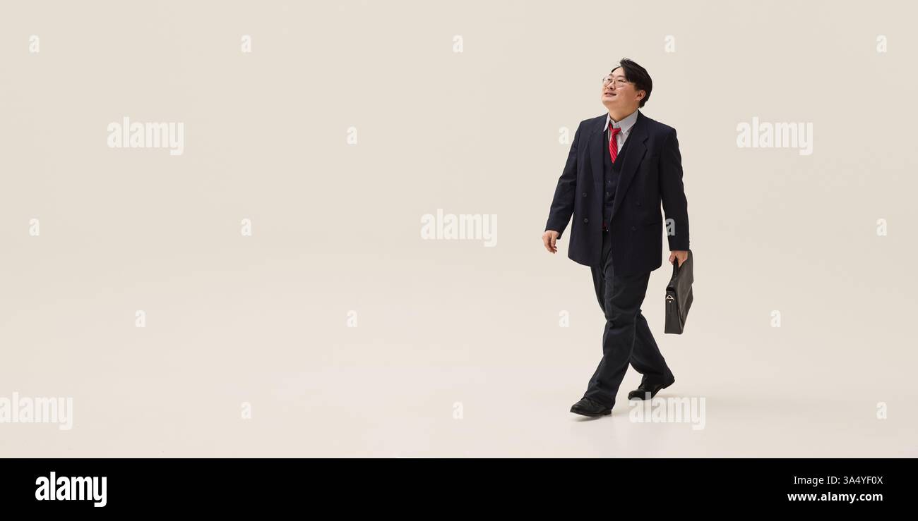 Dynamic photo of young attractive Asian man dressed formal attire ...