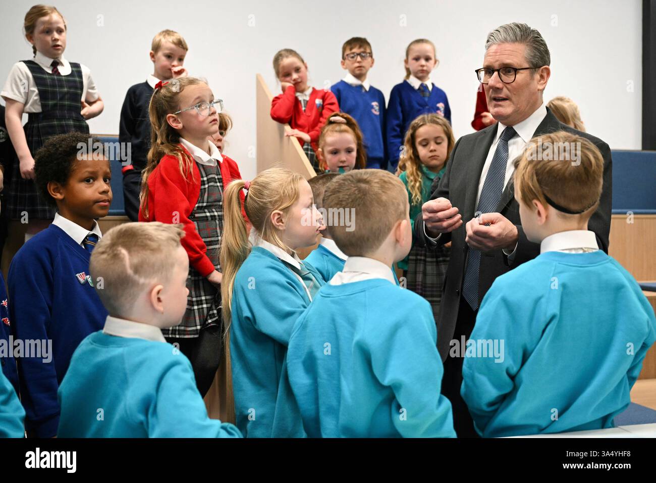 Britain's Prime Minister Keir Starmer speaks to school children taking ...
