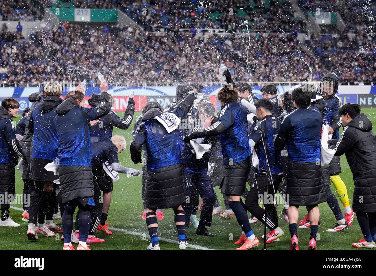 Japan players celebrate with their coach Hajime Moriyasu, center, after ...