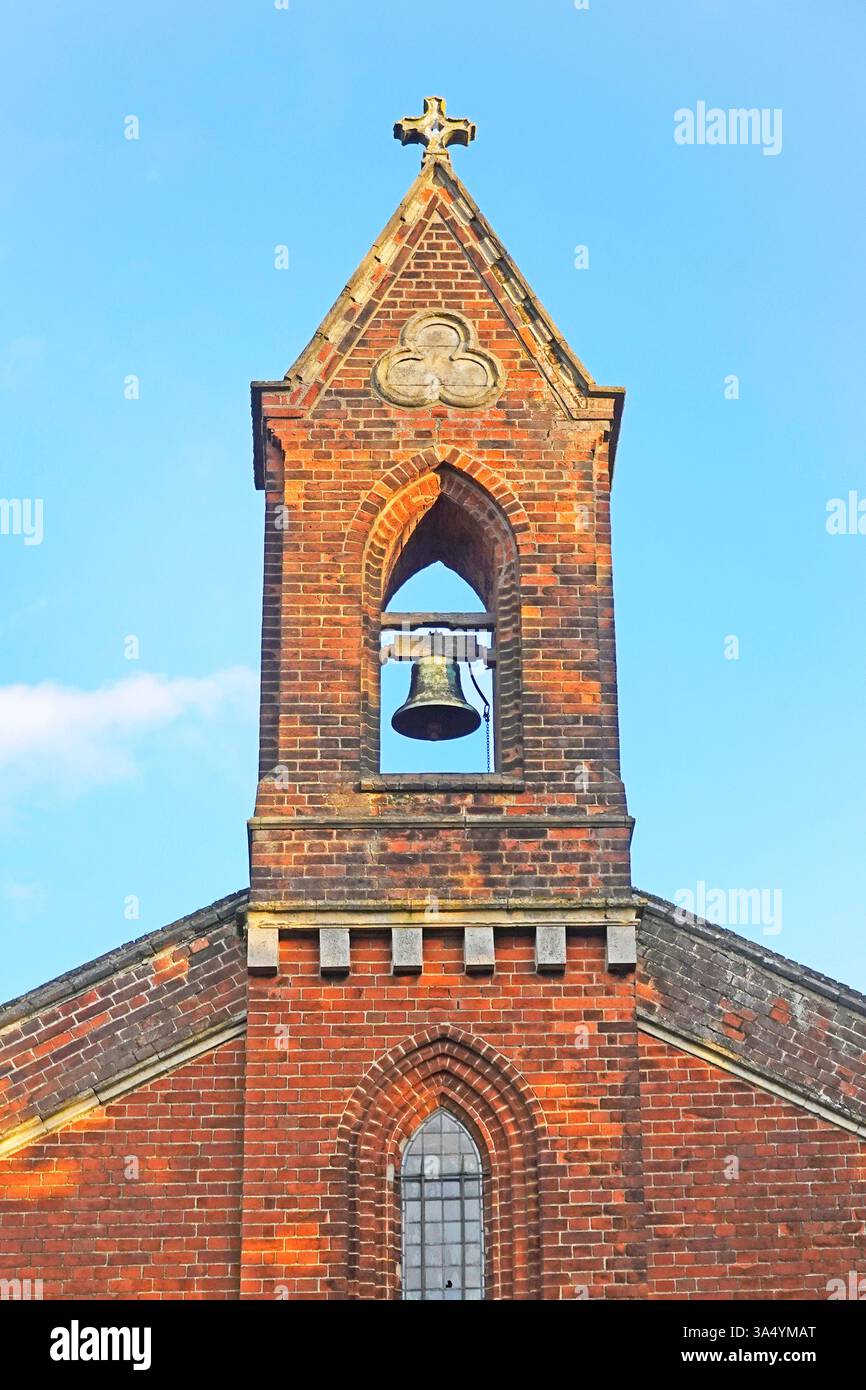 Close up of red brick built church tower & gable apex with single ...