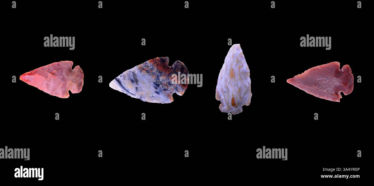 Handmade stone flint Arrow points isolated over a black background ...