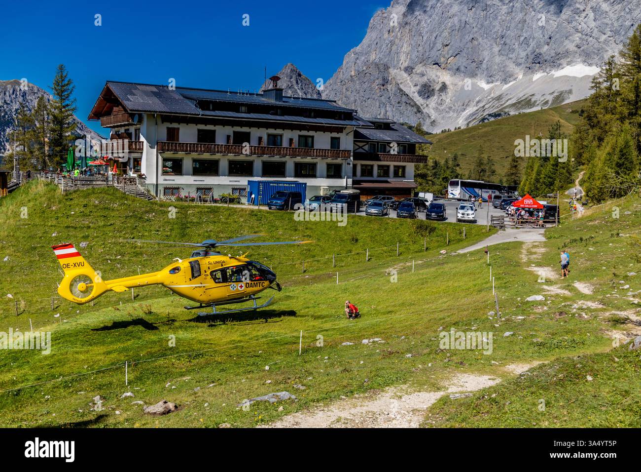 Rescue helicopter in the Alps. Heli flying high in the mountains and ...