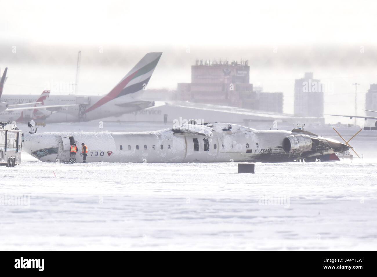 A Delta Air Lines plane lies upside down at Toronto Pearson Airport on ...