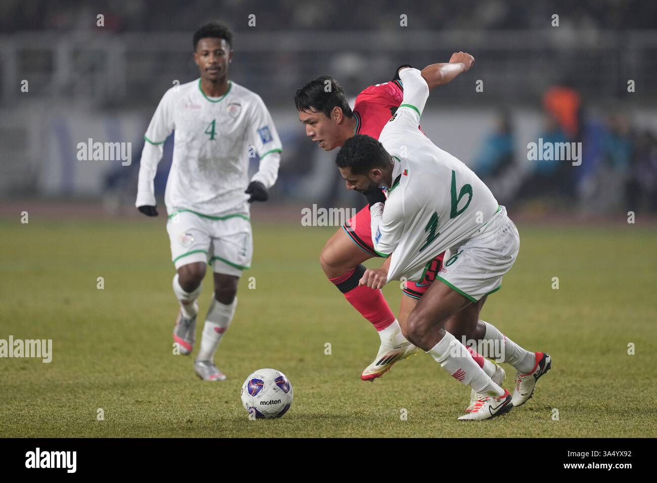 Oman's Khalid Nasser Al Braiki, right, fights for the ball against ...