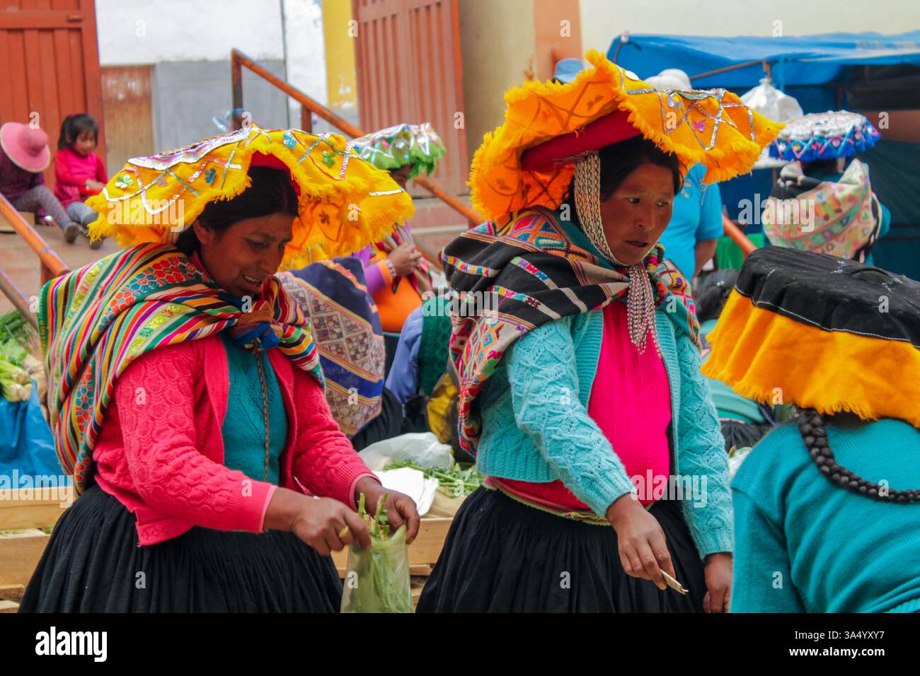 Women in traditional clothes and hats at the local market in Peru ...