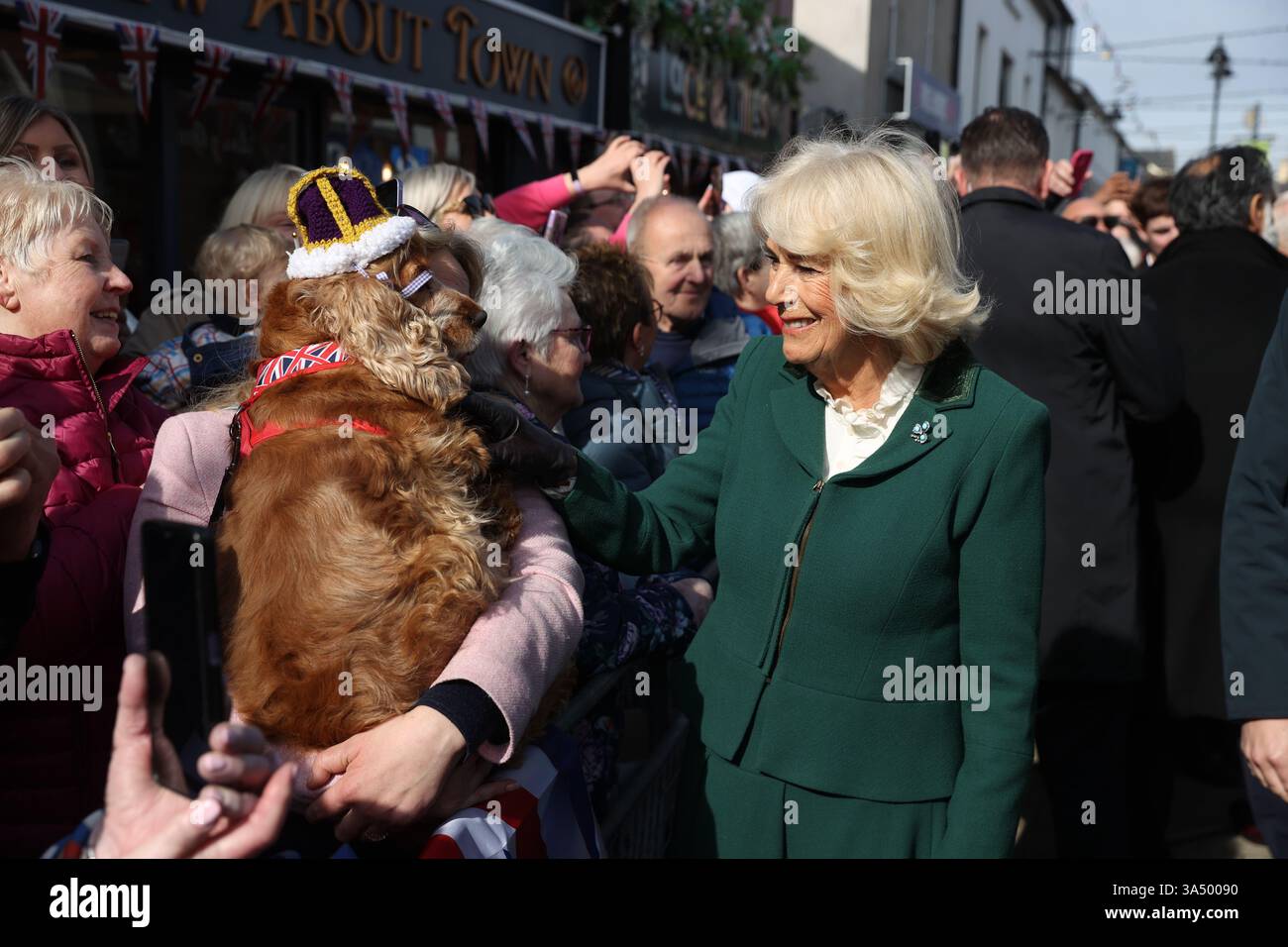 Queen Camilla talks with well-wisher Nadine Connor, holding her dog ...