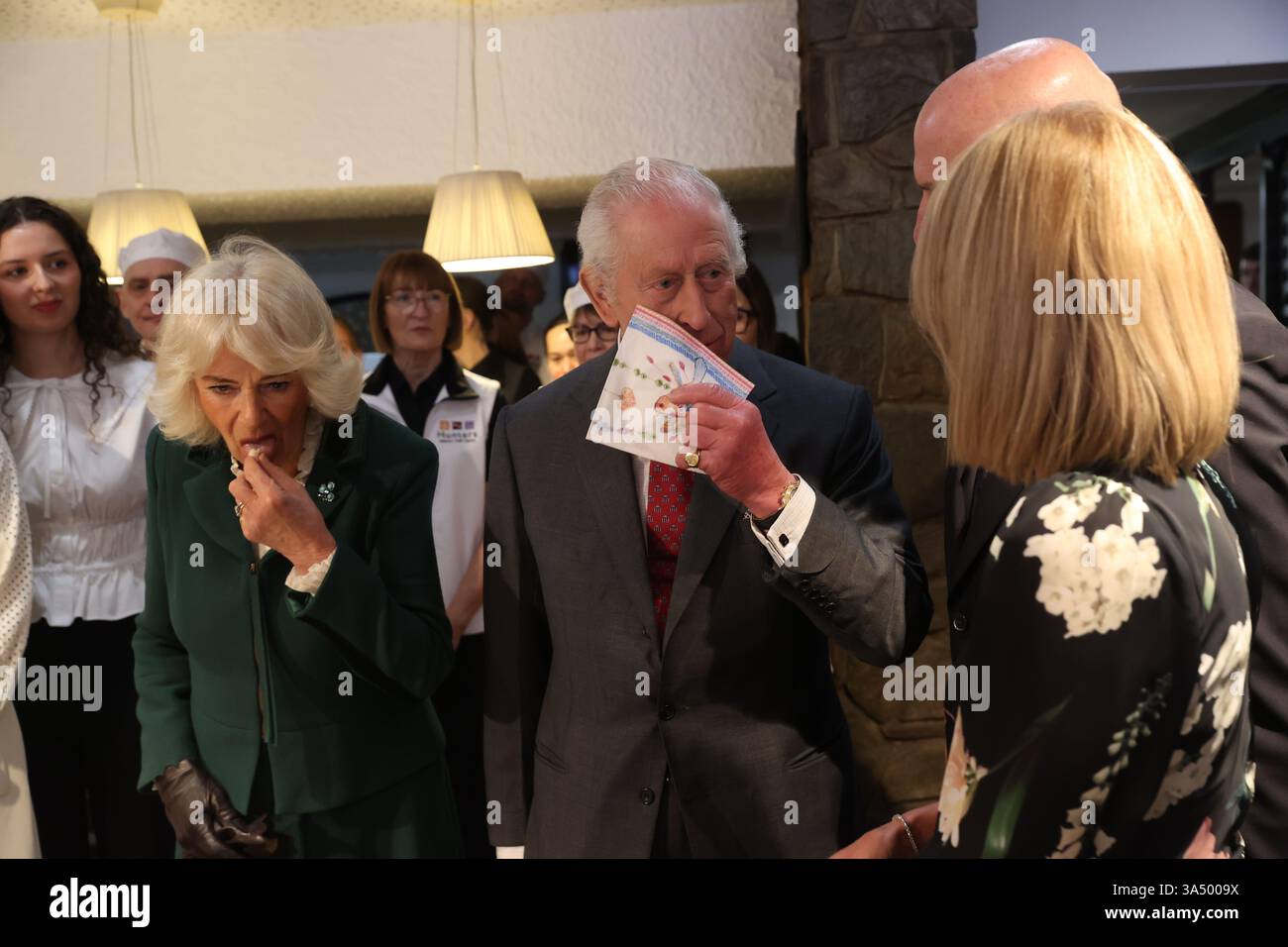 King Charles III and Queen Camilla taste a cake they cut into at ...
