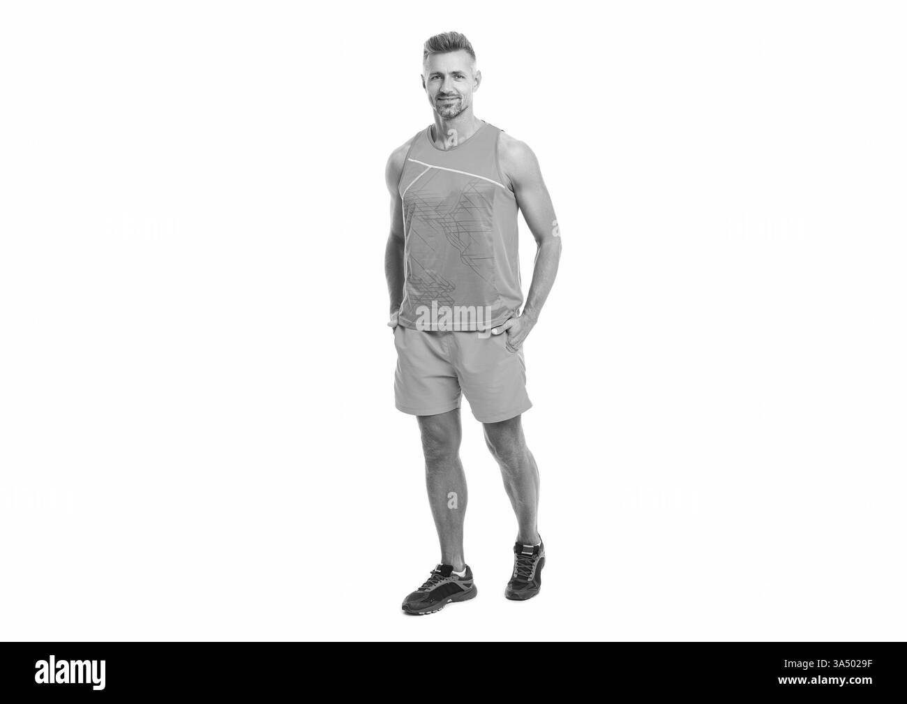 happy athlete wearing sport wear standing alone. The male sport athlete ...