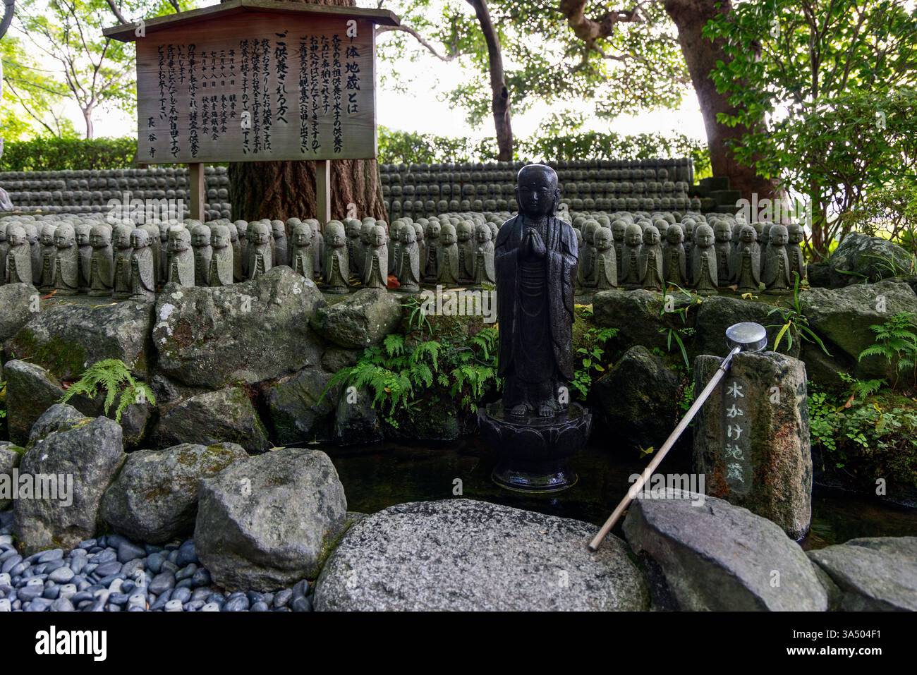 Jizo statues at Hase-dera temple in Kamakura Japan standing among moss ...