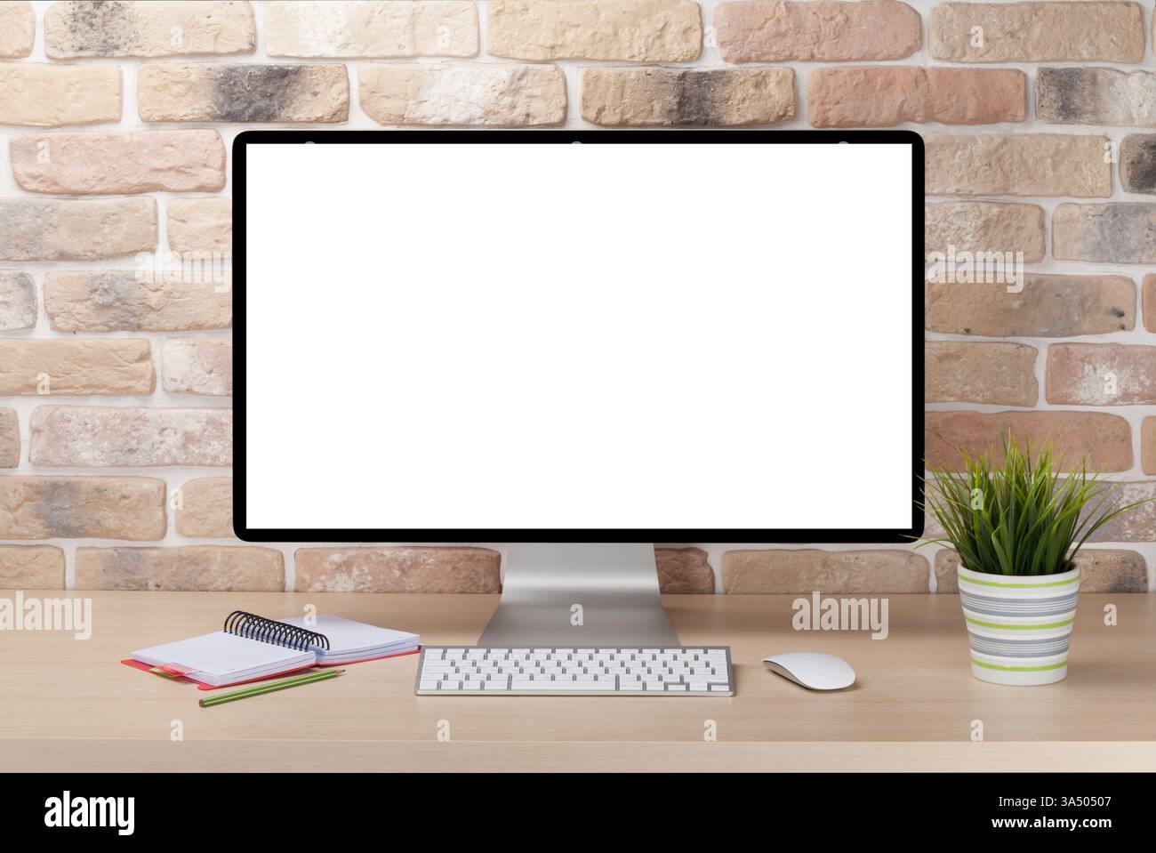 A cozy workplace setup featuring a PC with a blank screen monitor on a ...