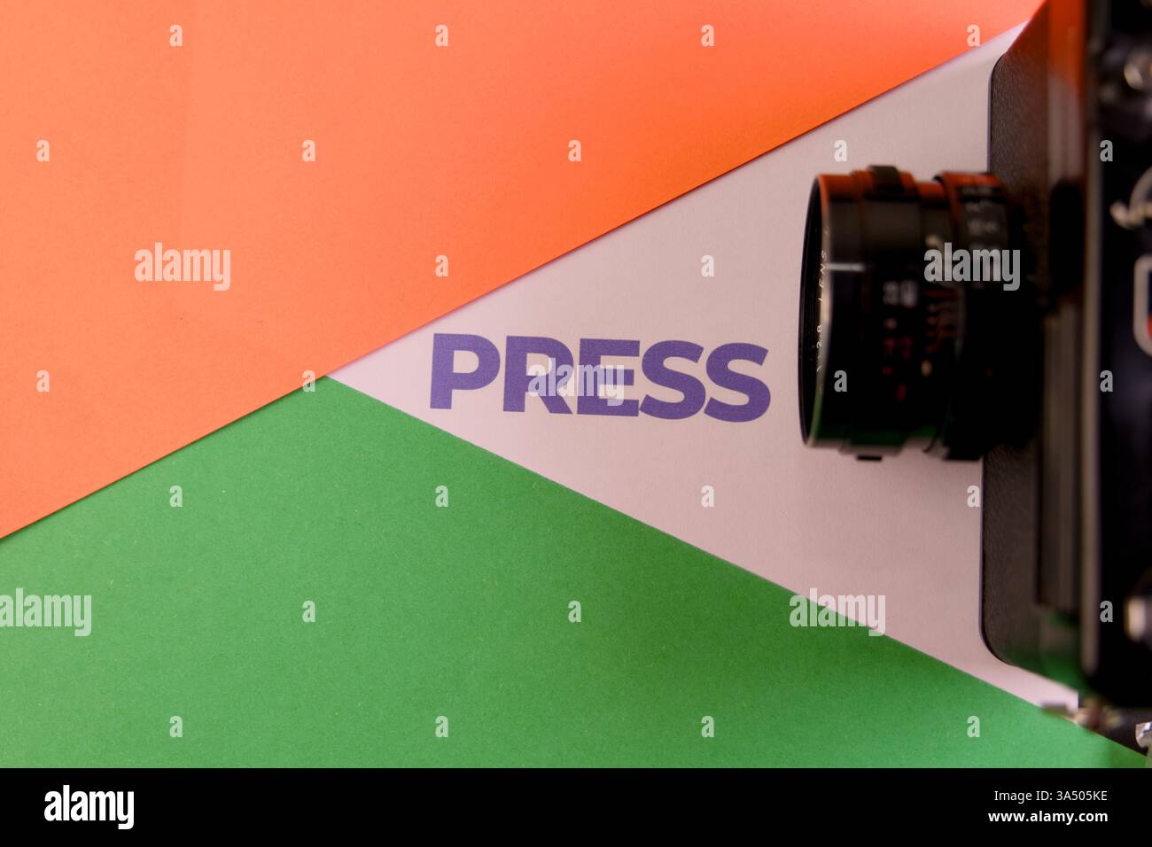 Camera placed on colorful paper background featuring press text and ...