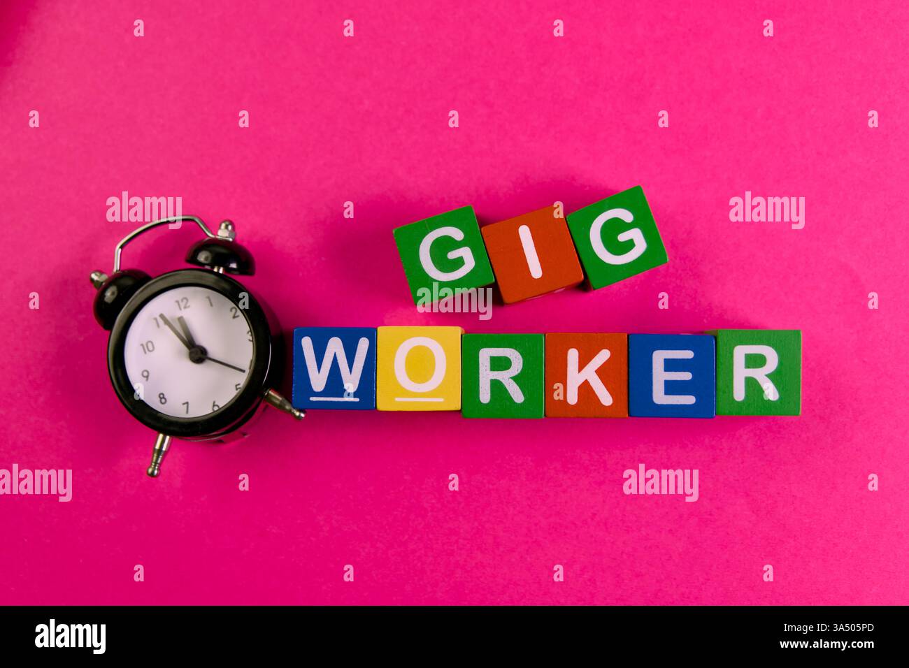 Colorful blocks spell out gig worker beside an alarm clock on a vibrant ...