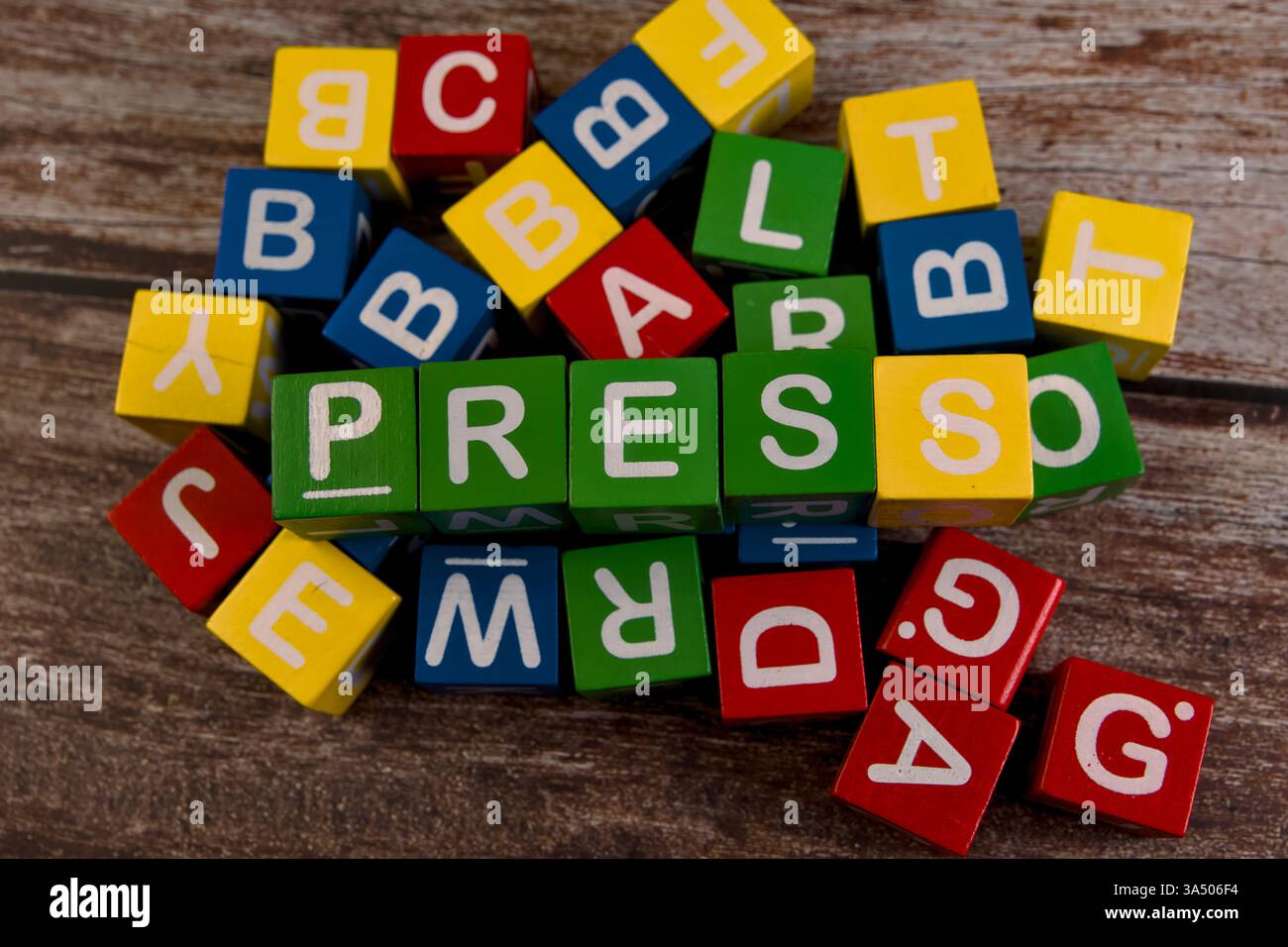 Brightly colored letter blocks are scattered, highlighting the word ...