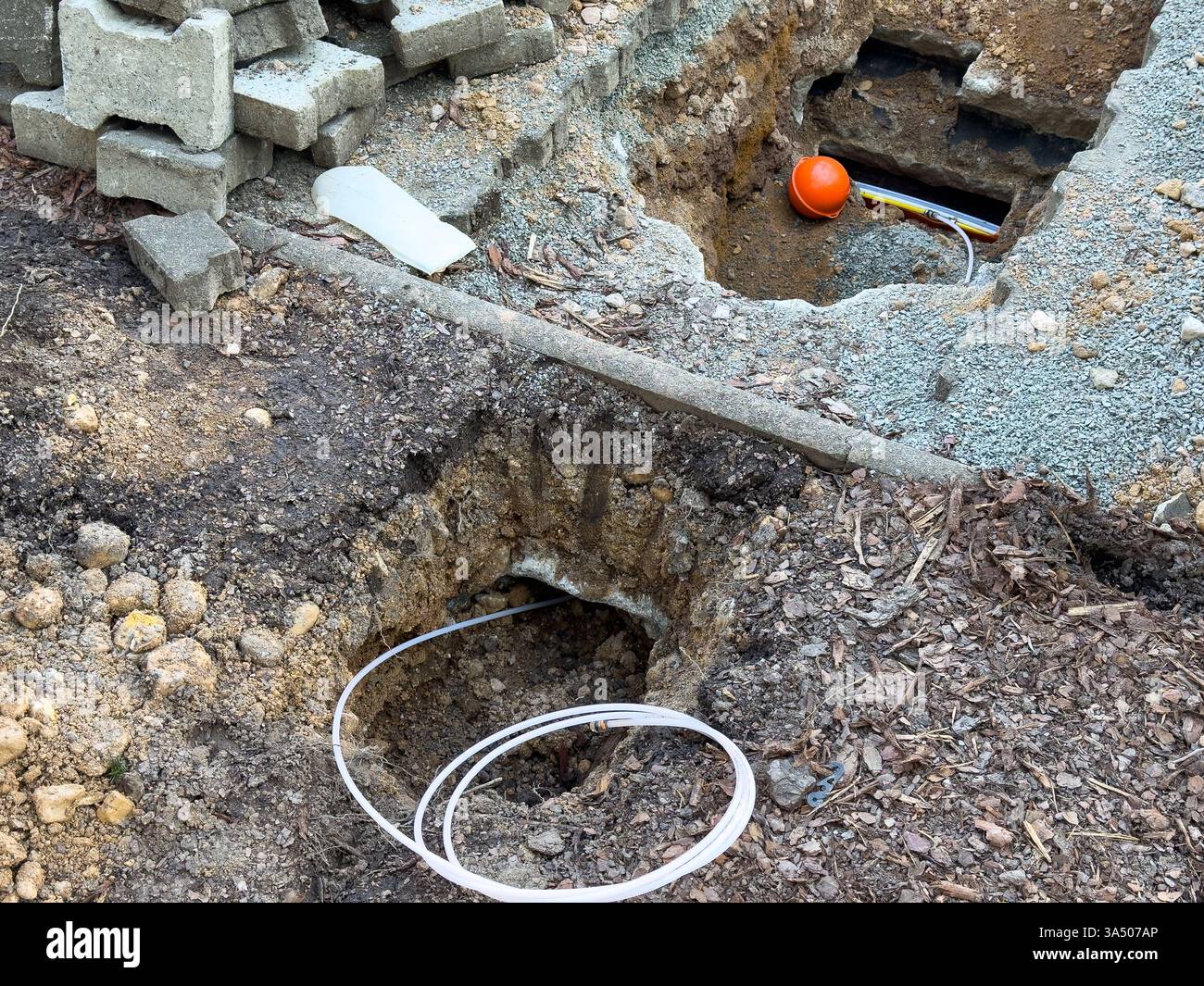 Laying a fiber optic cable for fast internet on the street Stock Photo ...