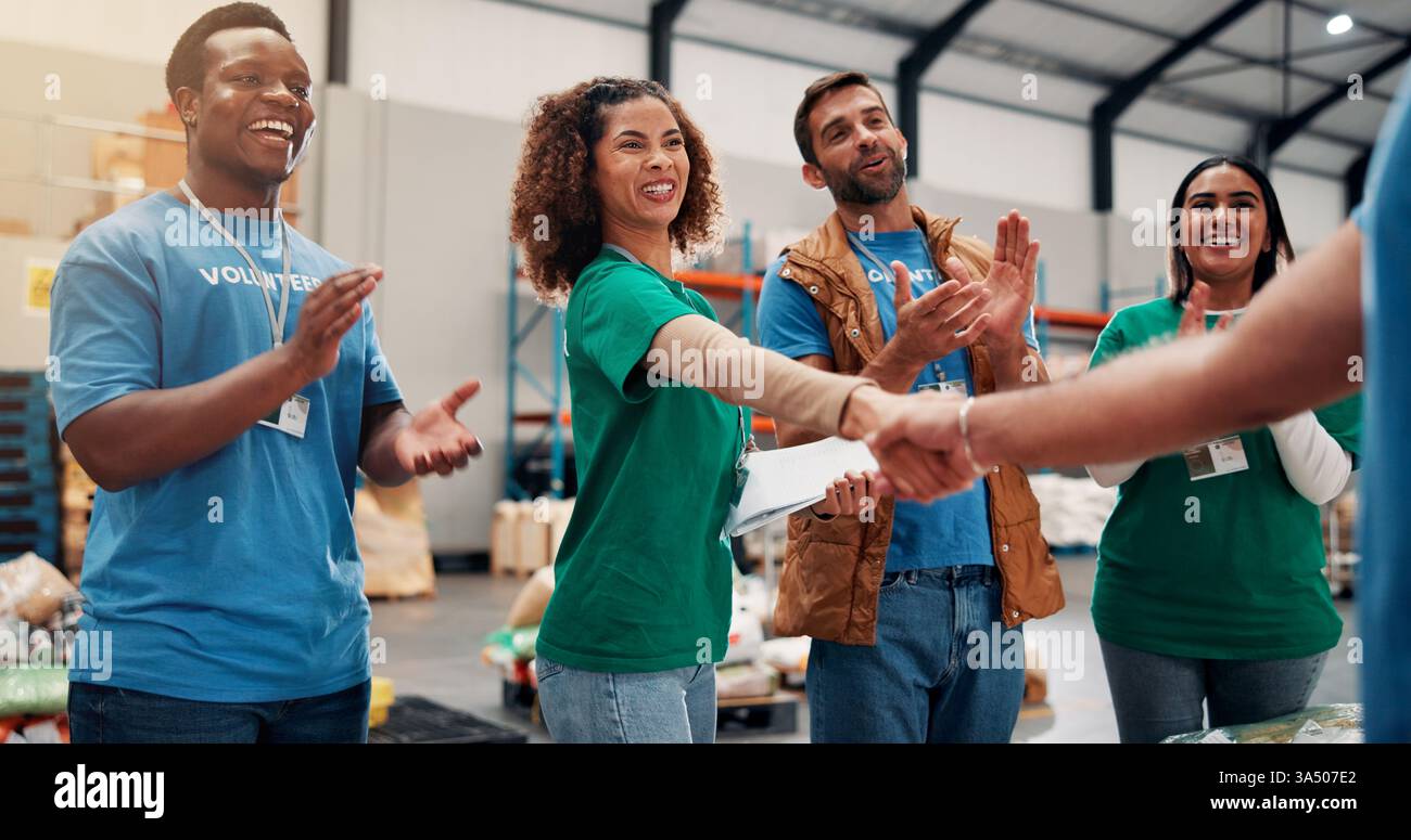 Applause, handshake and success with volunteer team in warehouse ...