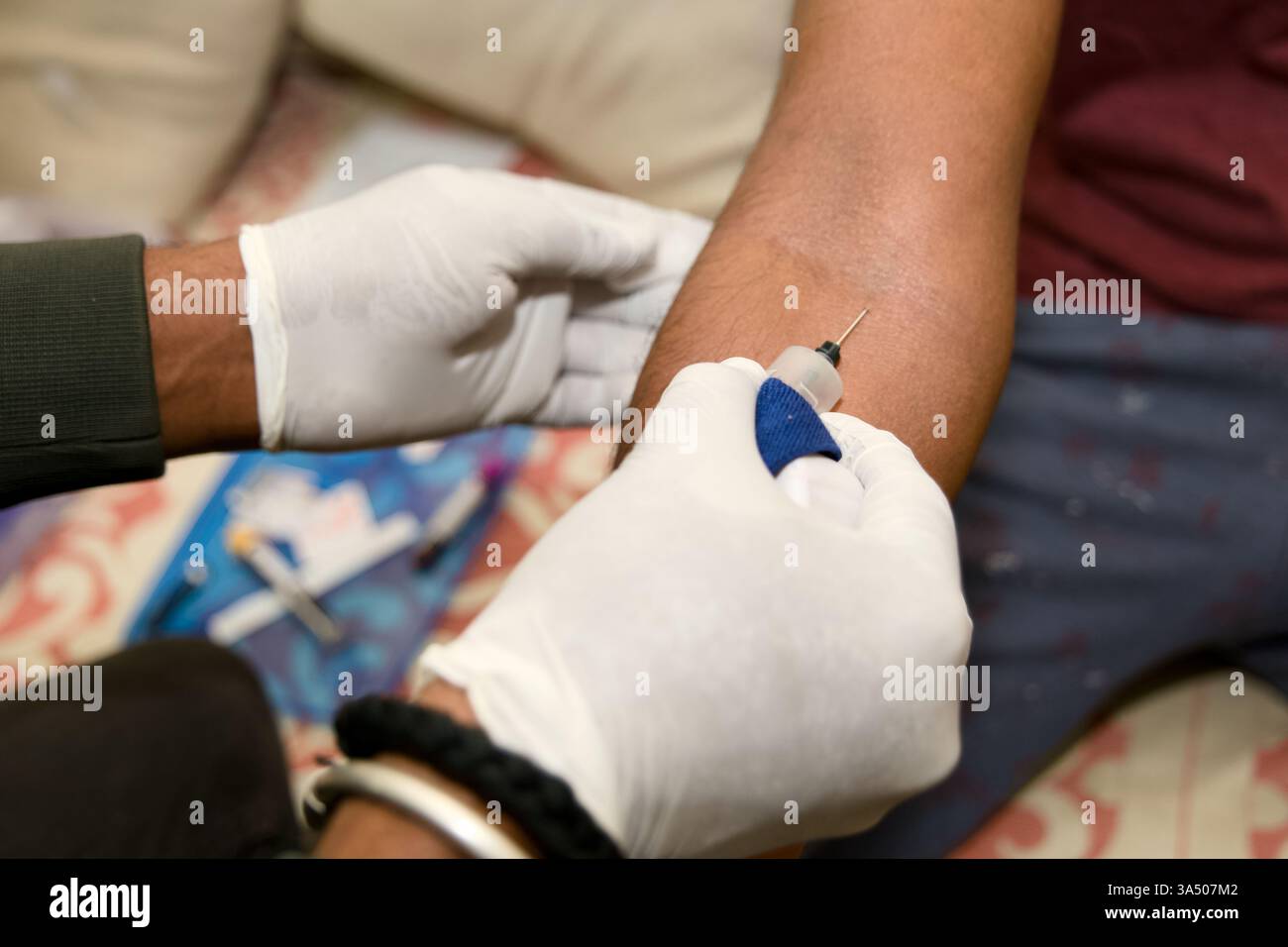 Healthcare professional draws blood from arm for donation ...