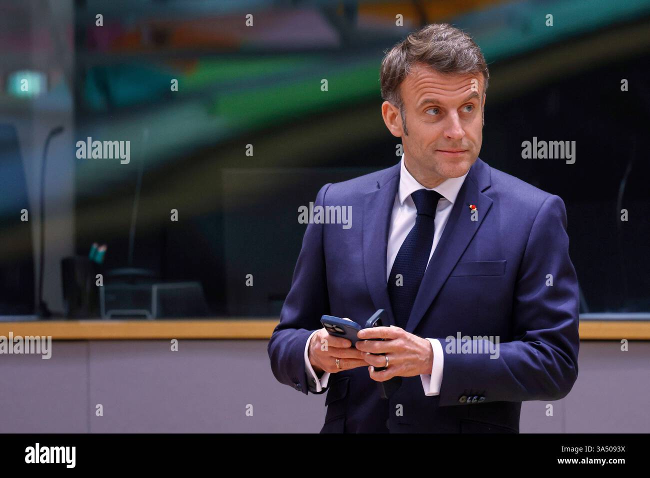 French President Emmanuel Macron waits for the start of a round table ...