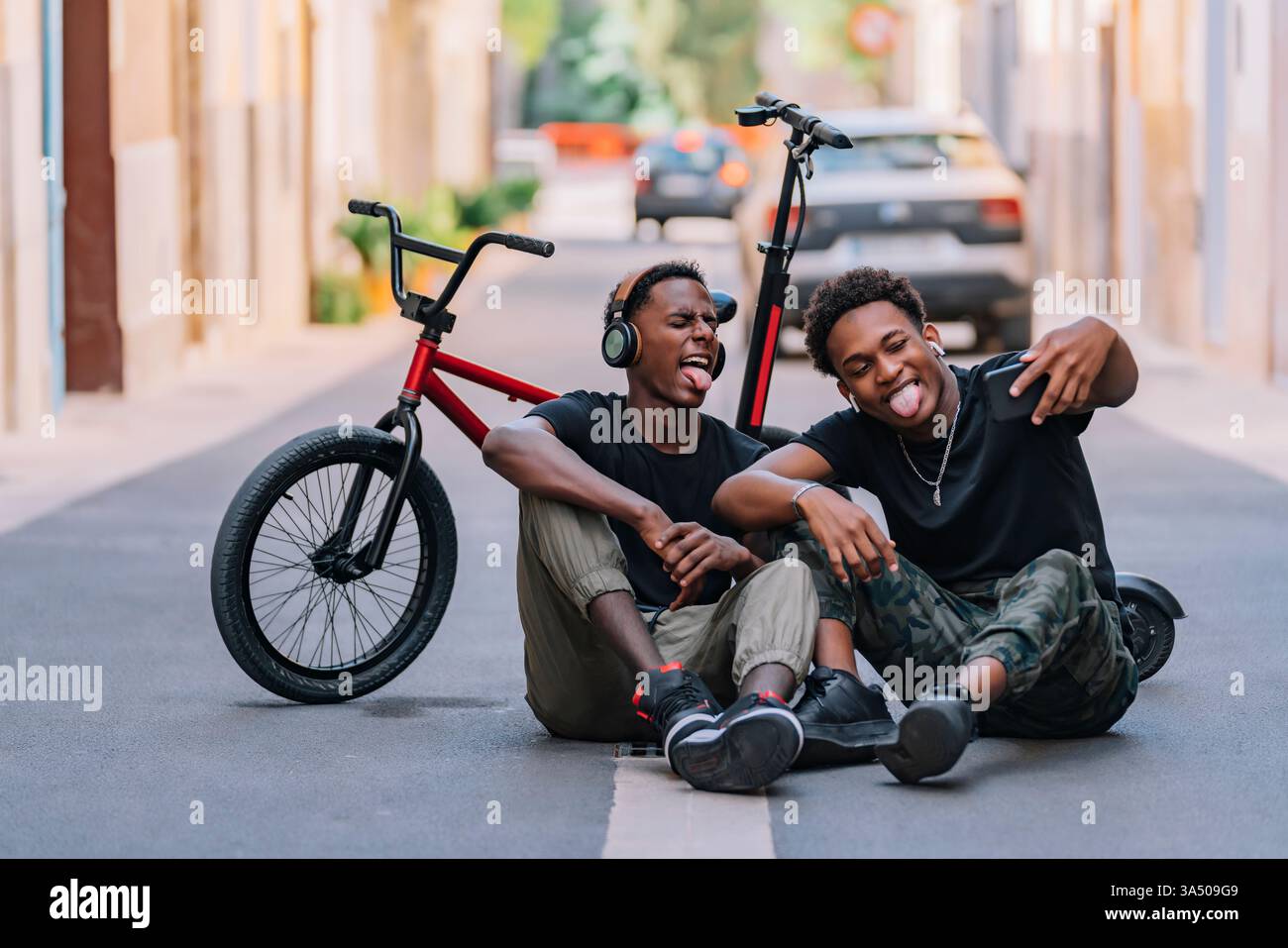 Native American young men taking selfie on cellphone sitting together ...