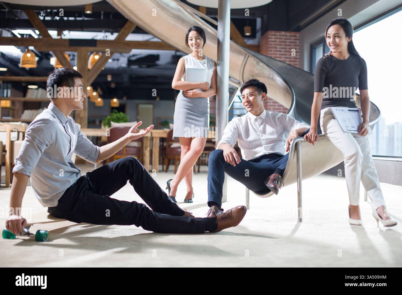 Young Chinese business person talking in office Stock Photo - Alamy