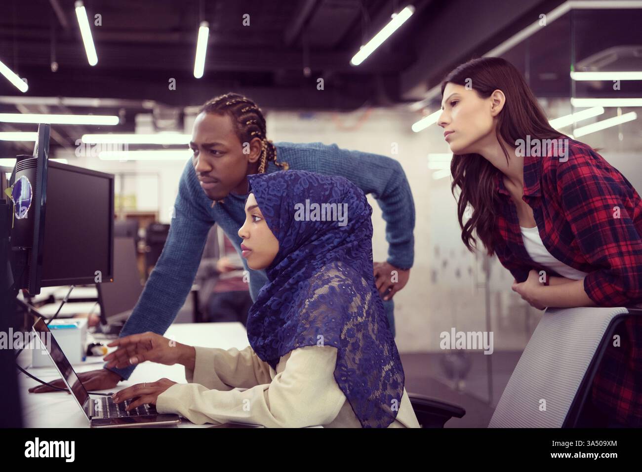 Black business people using computer working together with white female ...