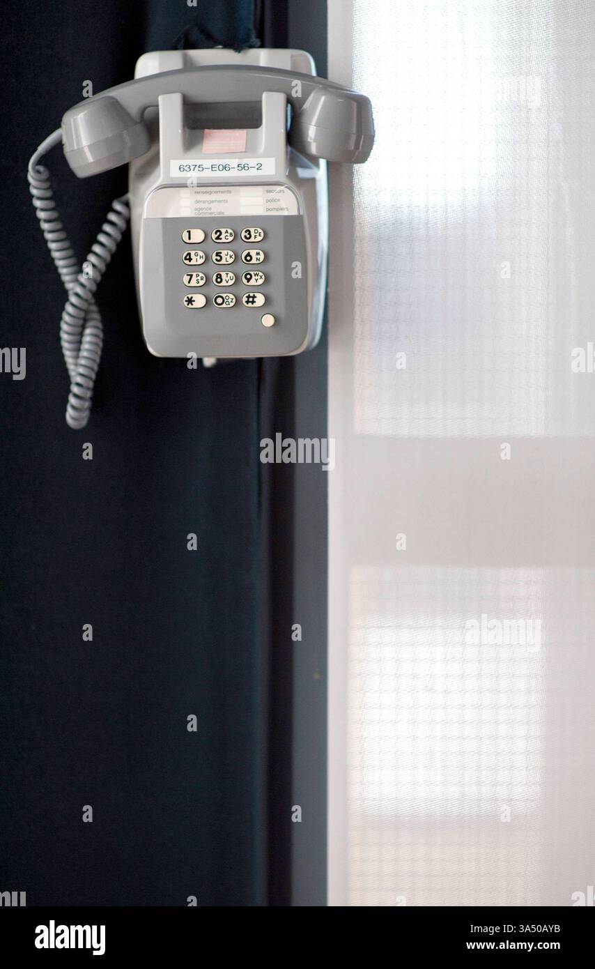 Analog Telephone. Vintage, Analog Telephone mounted on an interior wall ...