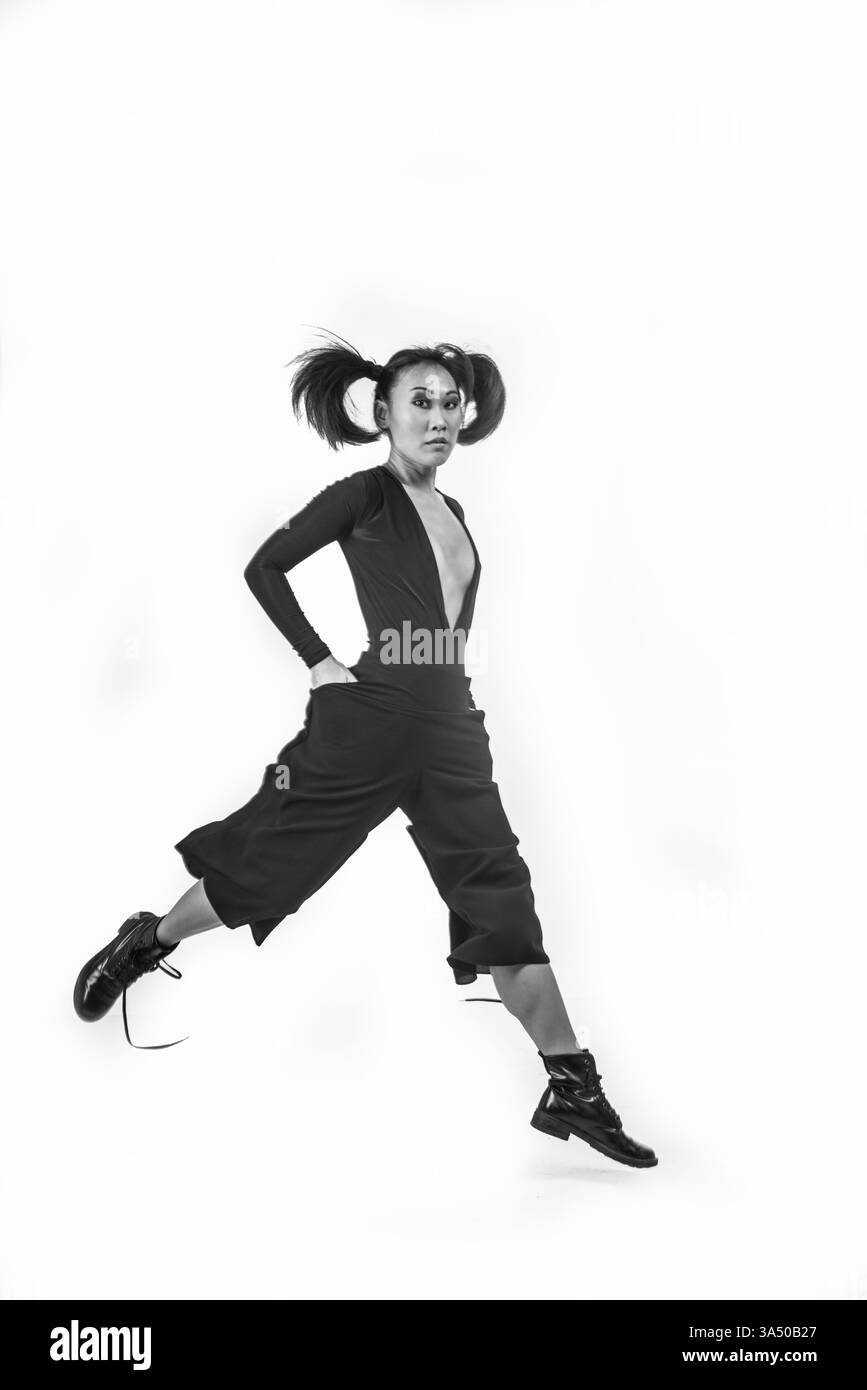 Korean woman jumping against white background Stock Photo - Alamy