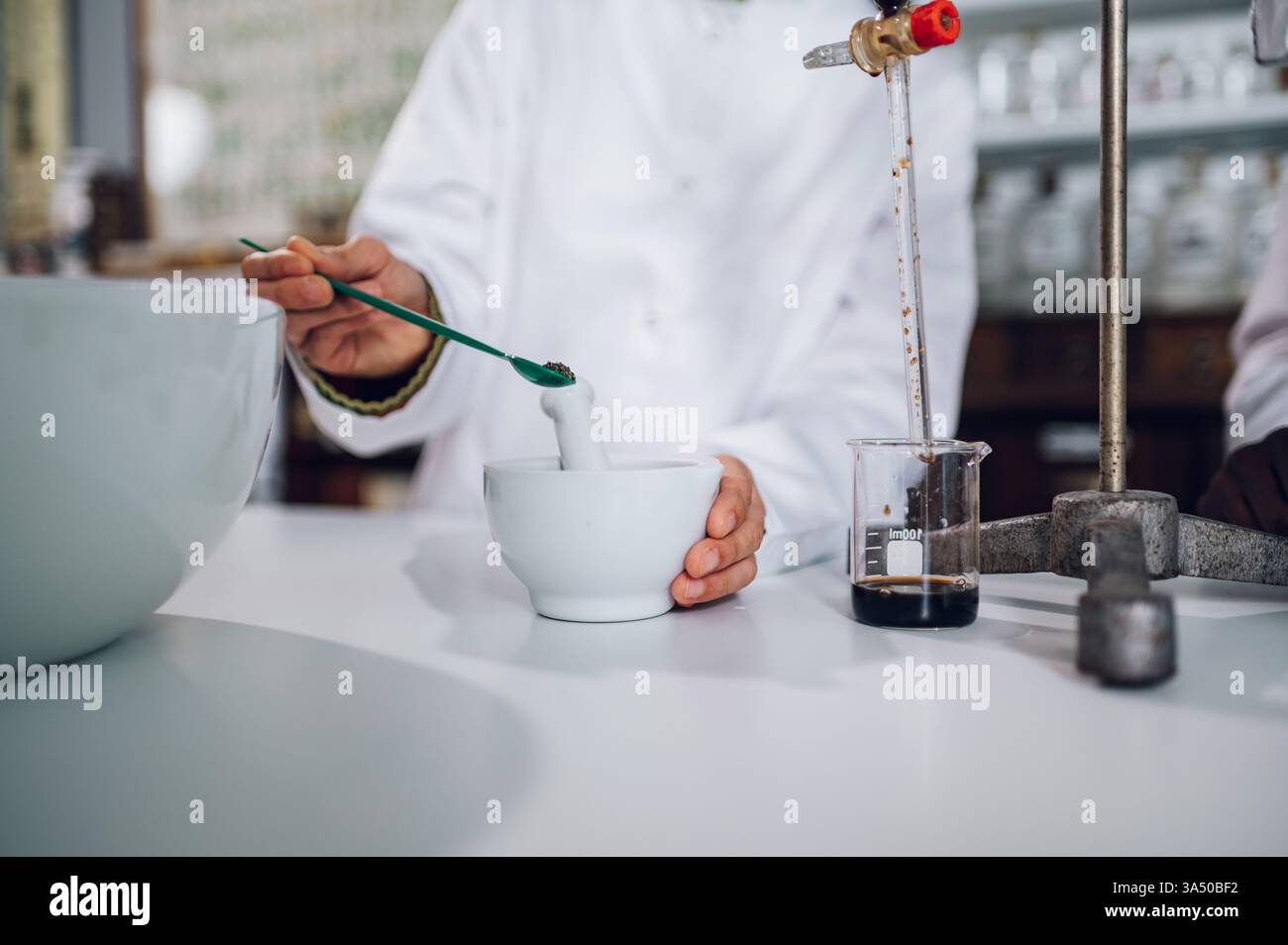 Cropped picture of an unrecognizable apothecary technician adding an ...