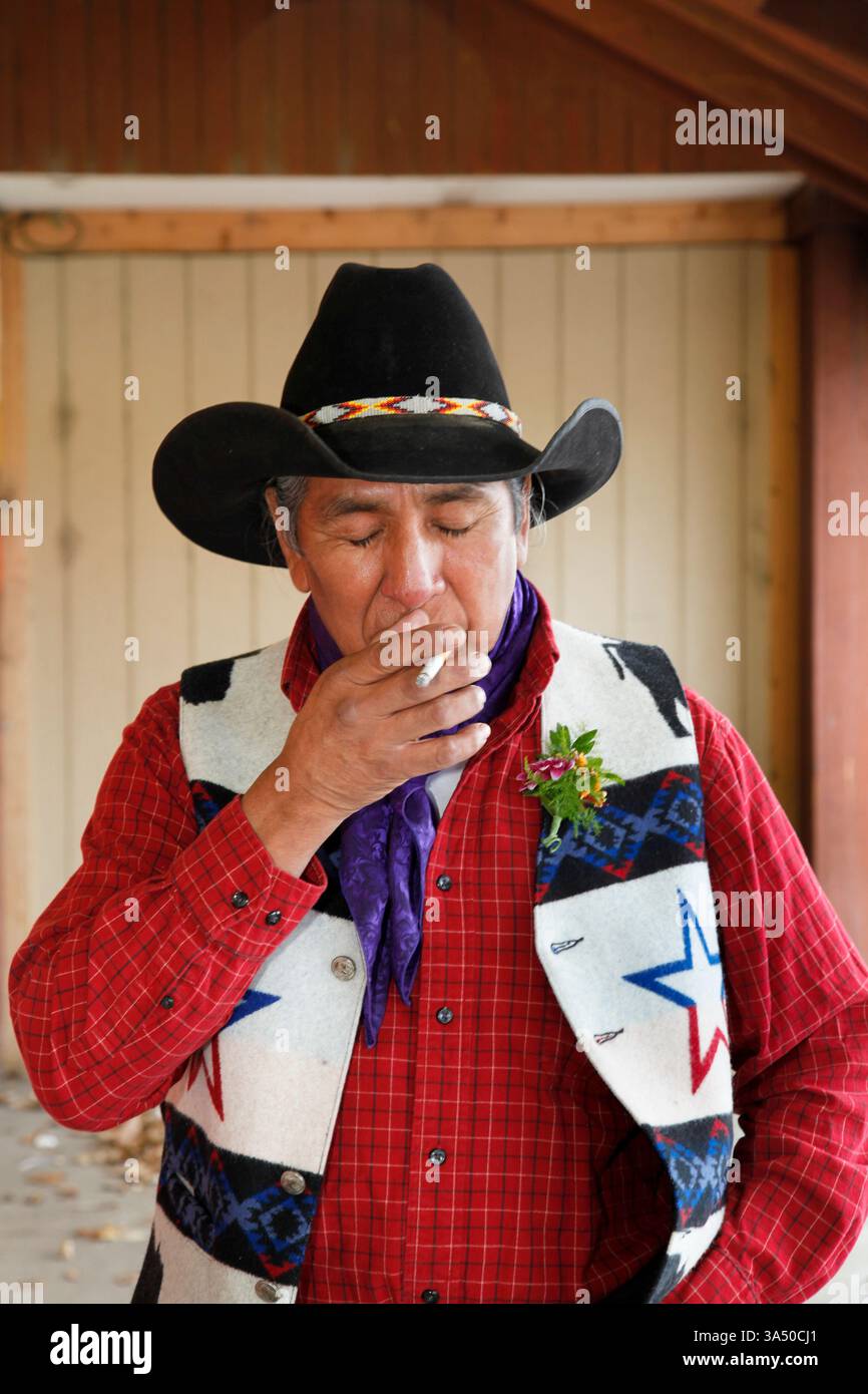 Native American senior man in cowboy clothing and hat looking away ...