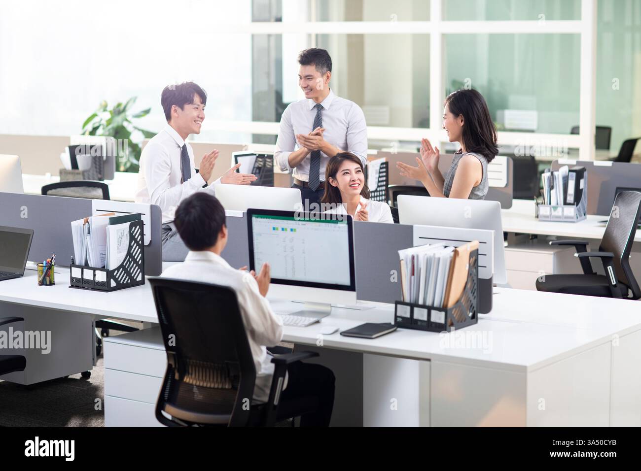 Cheerful Chinese business people clapping hands celebrating success in office Stock Photo - Alamy