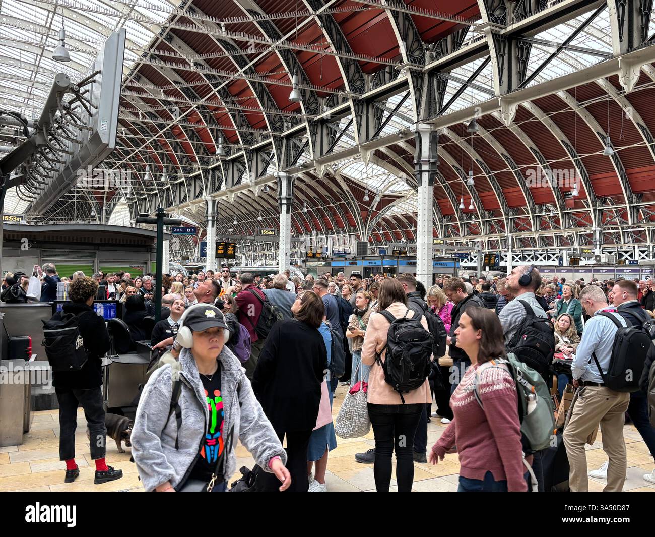 Passengers queue for trains at Paddington Station in London. Picture ...