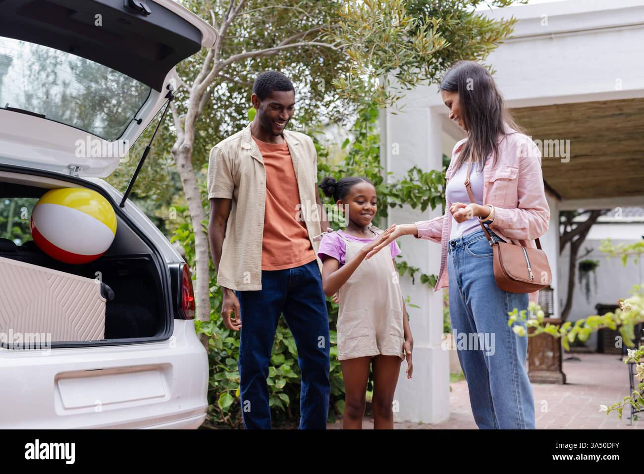 Packing car for vacation, happy family enjoying time together outdoors ...