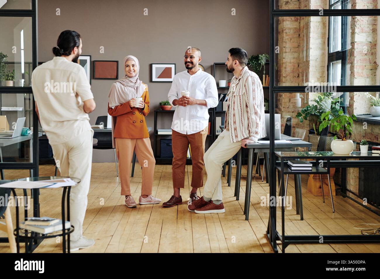 Group of office workers having conversation standing next to each other ...