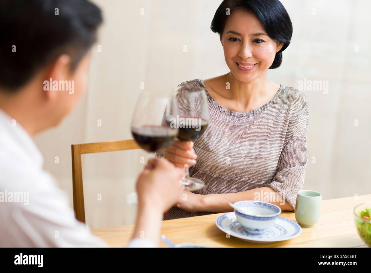 Mature Chinese couple toasting Stock Photo - Alamy