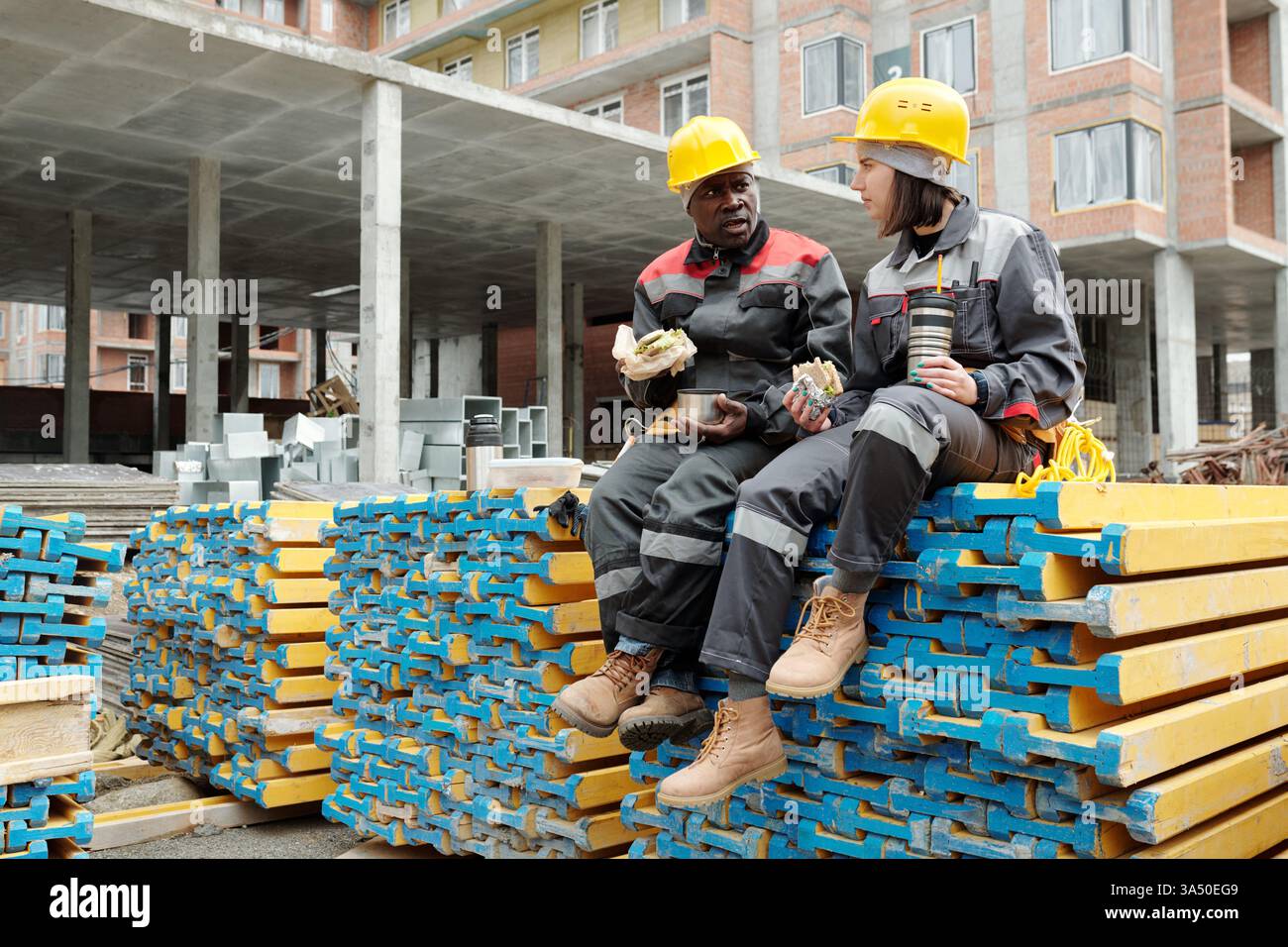 Black man worker having snack with caucasian female co worker sitting ...