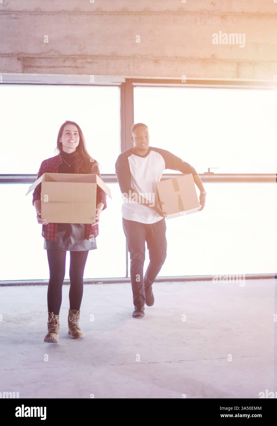 happy young multiethnic casual business team carrying cardboard boxes ...