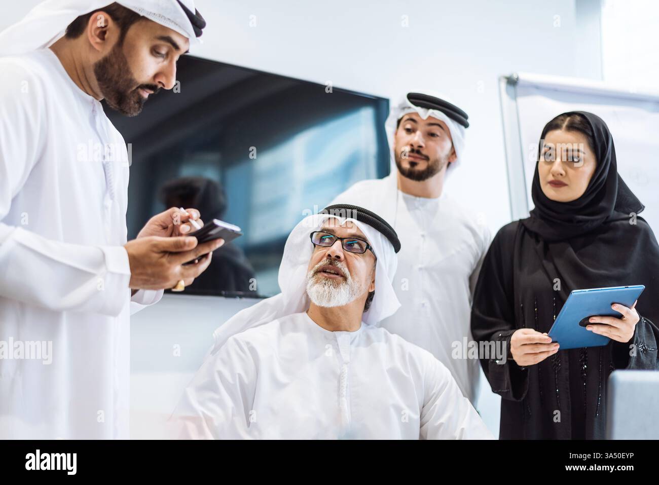 Middle Eastern corporate businessmen wearing kandura and Muslim ...