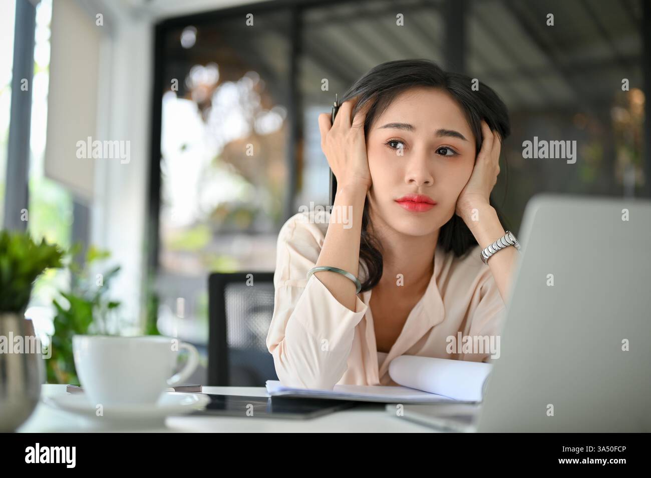 Stressed and thoughtful millennial Asian businesswoman or female office ...
