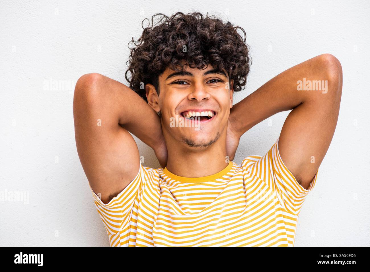 Close up portrait happy young North African man laughing with hands ...