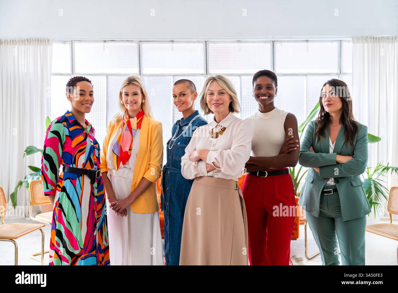 Cheerful diverse group of business women standing together in office Stock Photo - Alamy