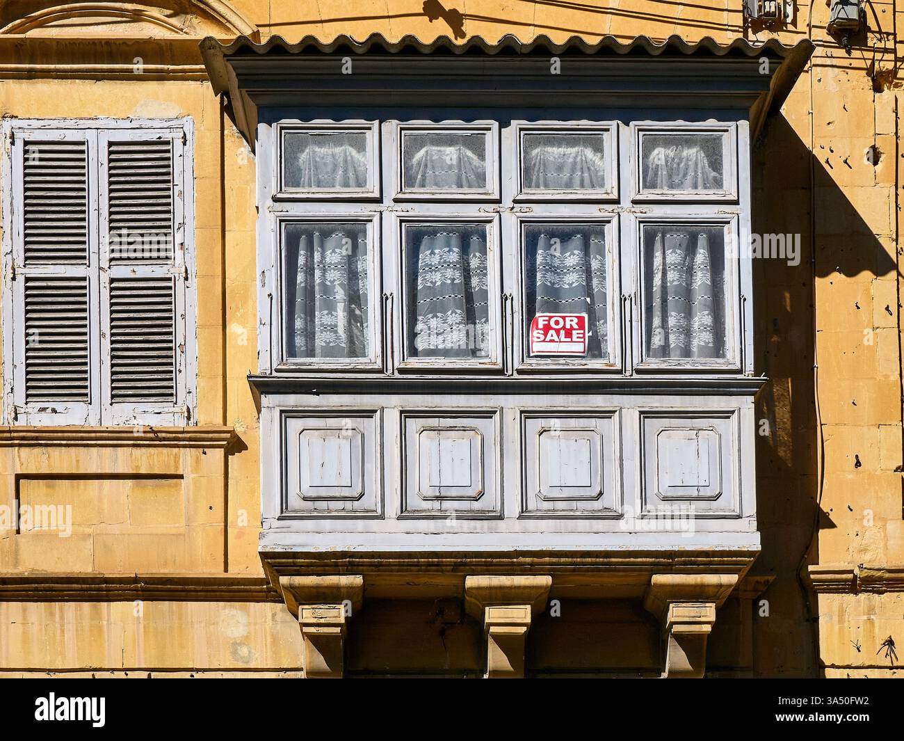 A typical Maltese balcony with a ‘for sale’ sign in the window, Malta ...