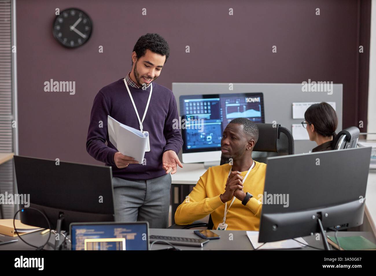 Portrait of two business analytics discussing project in high tech IT ...