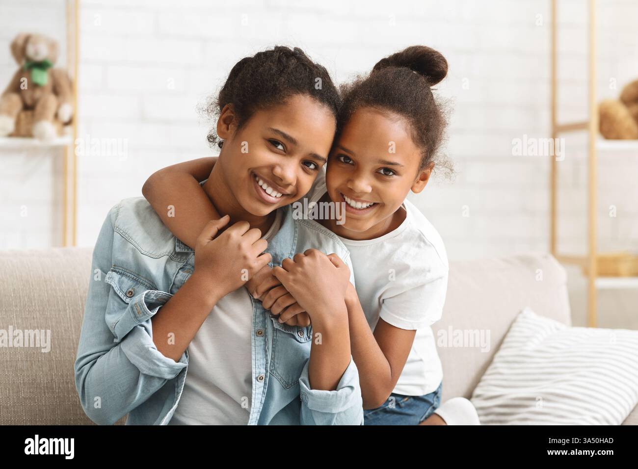 Happy sisterhood. Cute african american girls embracing at home, copy ...